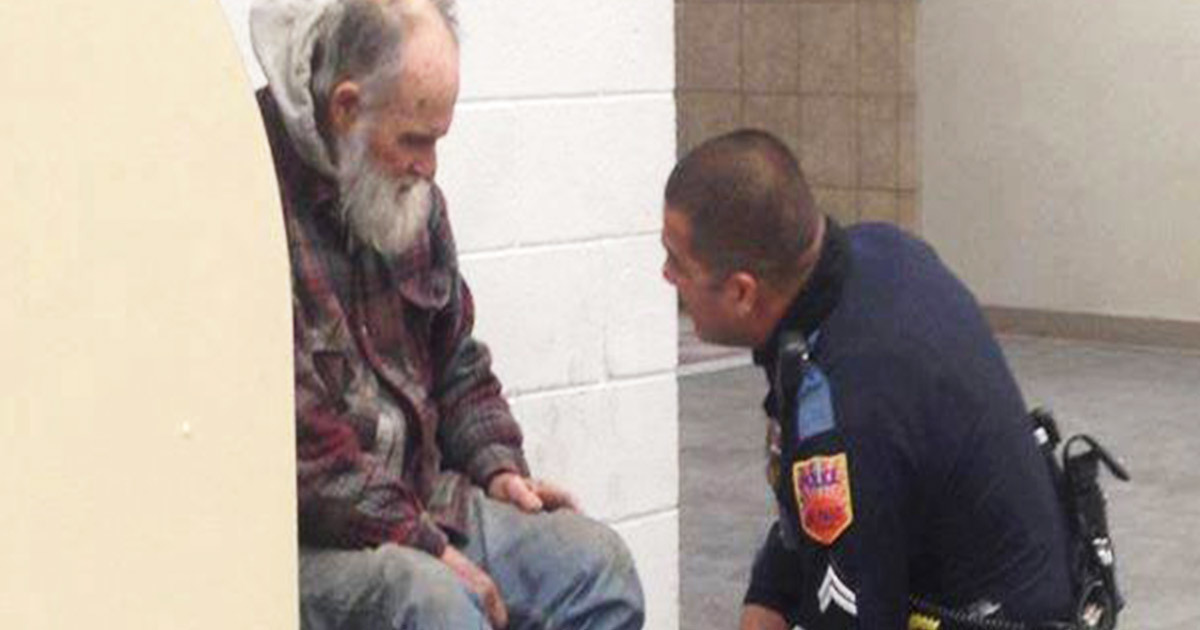 Homeless Man And Police Officer Sitting On A Bench